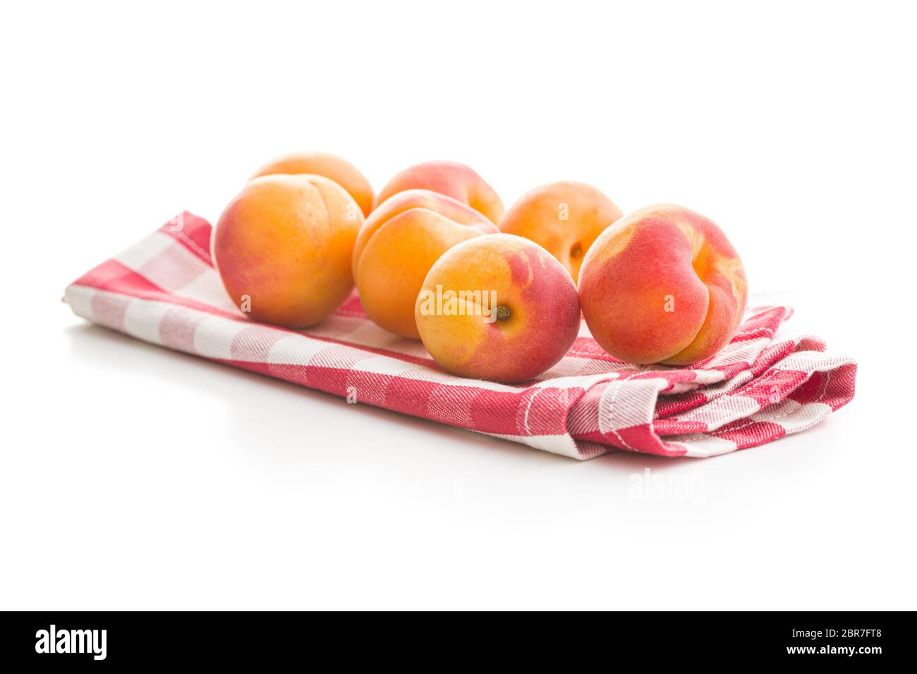 Sweet apricot fruits on checkered napkin isolated on white background ...