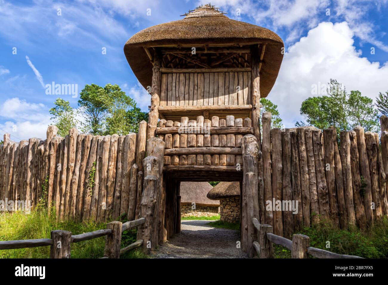 Entrance trough gate in palisade and guard tower to old thatch and ...