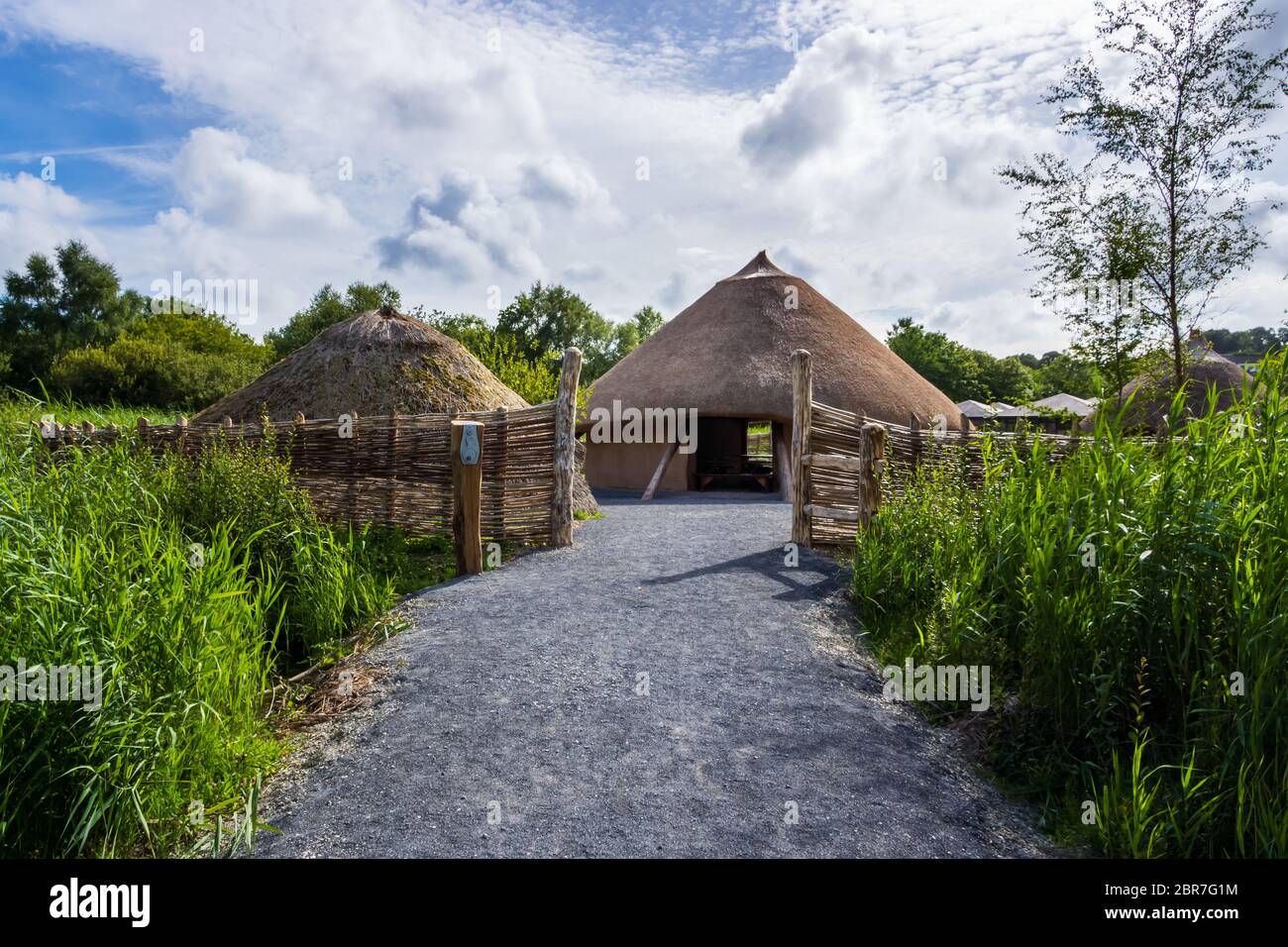 Entrance trough gate to old thatch, straw Celtic cottage , concept of ...