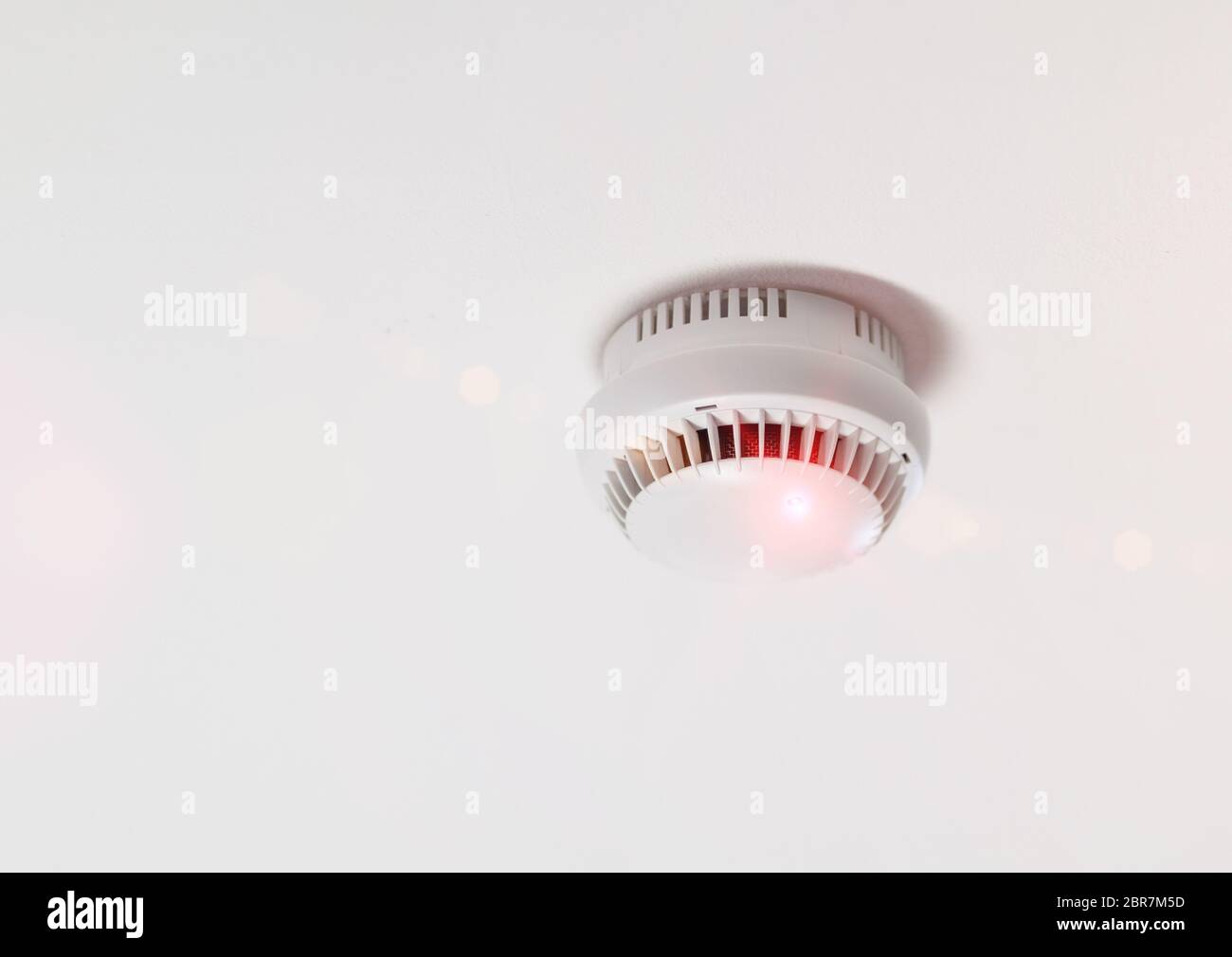 Smoke detector mounted on roof in apartment Stock Photo - Alamy