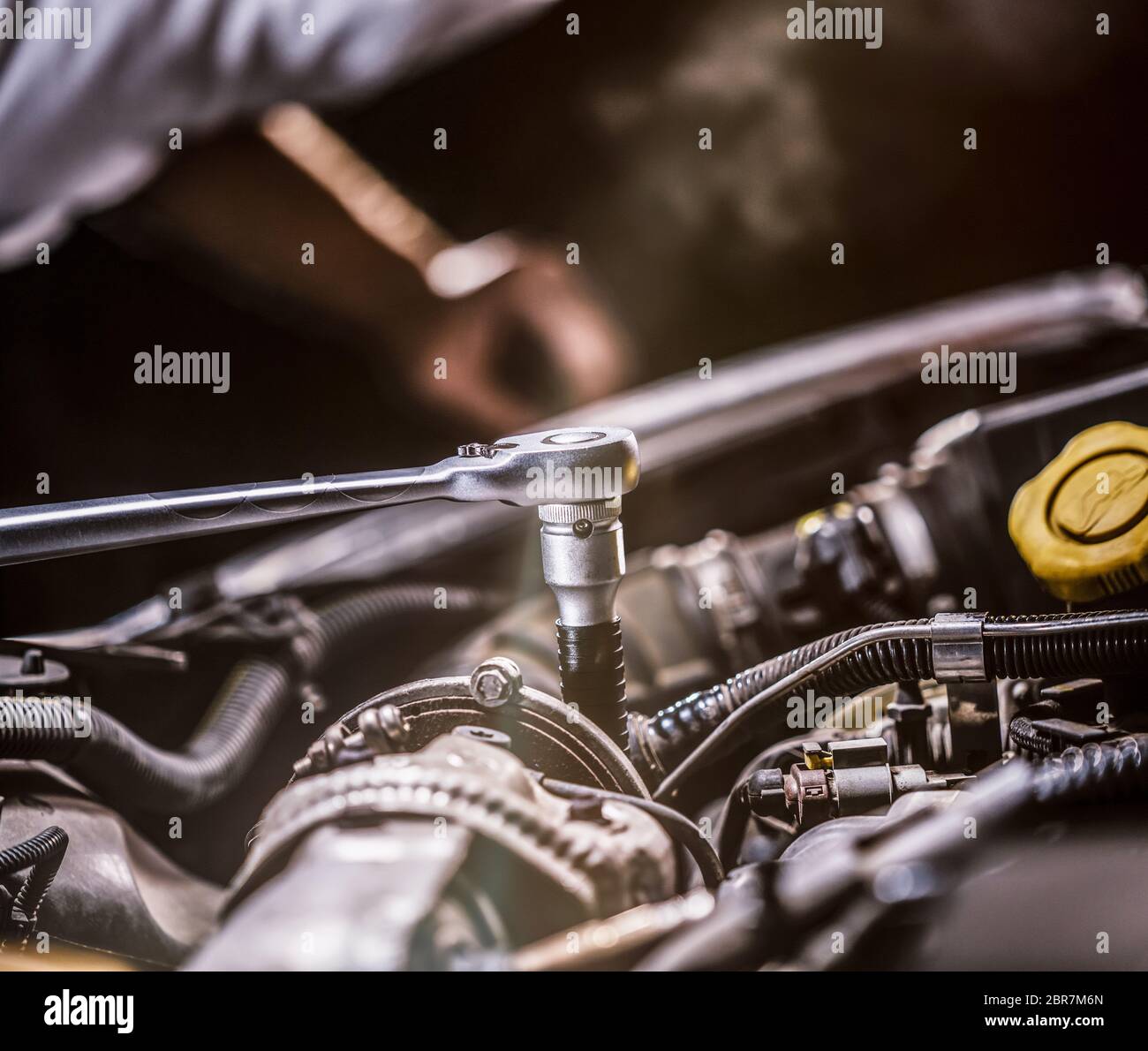 Auto mechanic working on car engine in mechanics garage. Repair service ...