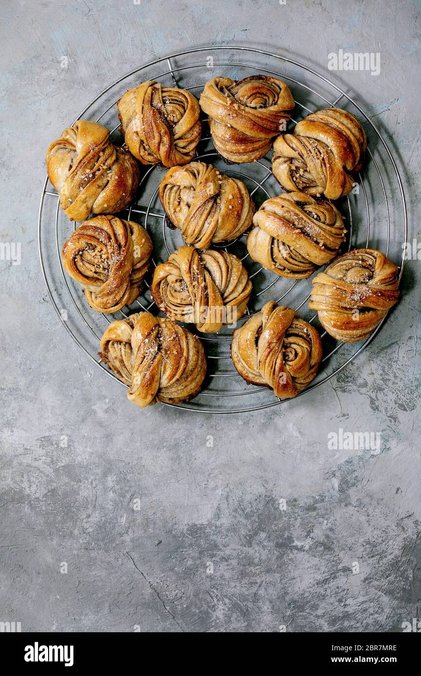 Traditional Swedish cardamom sweet buns Kanelbulle on cooling rack over ...