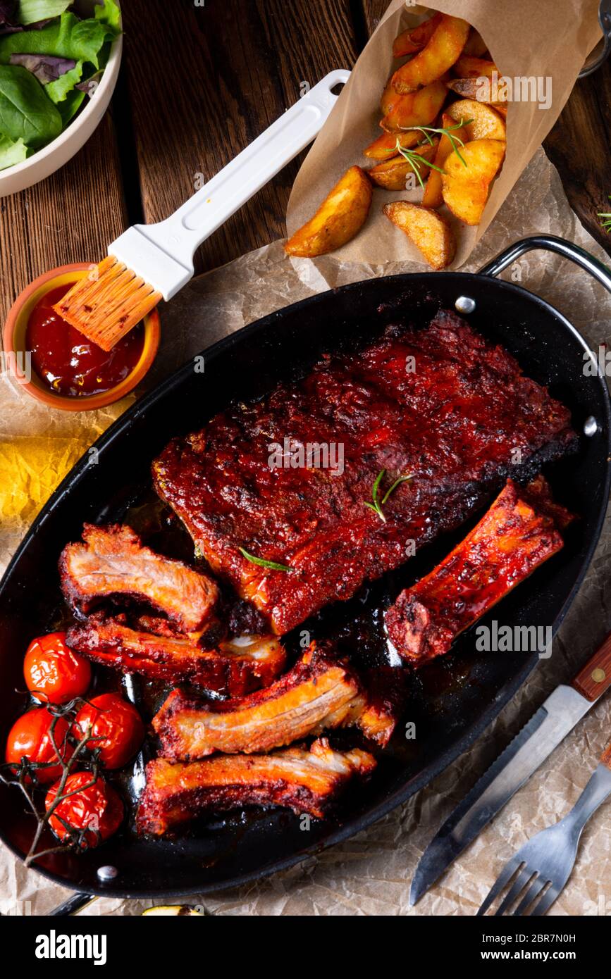 Grilled ribs in spicy marinade with salad and vegetables Stock Photo ...