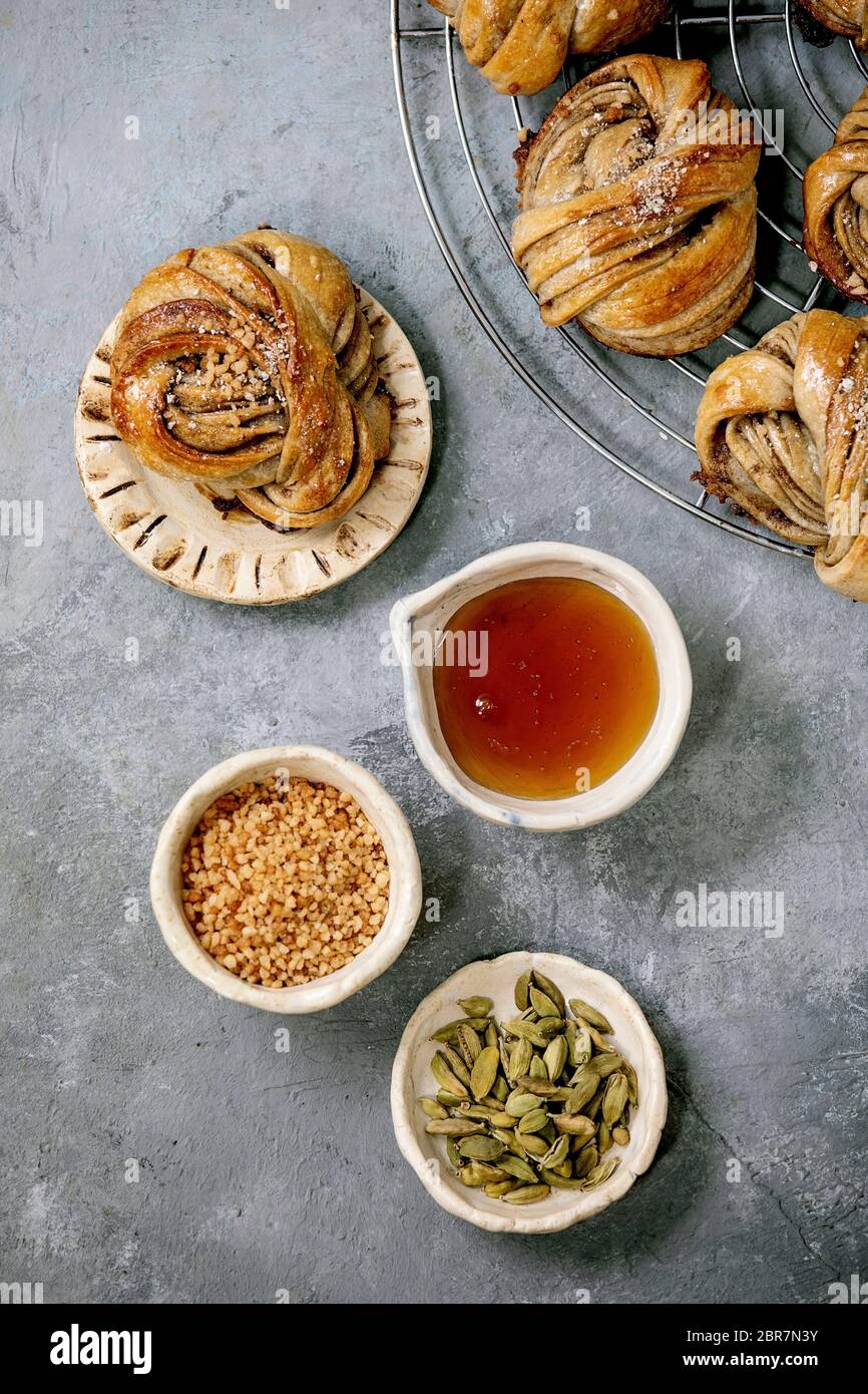 Traditional Swedish cardamom sweet buns Kanelbulle on cooling rack ...