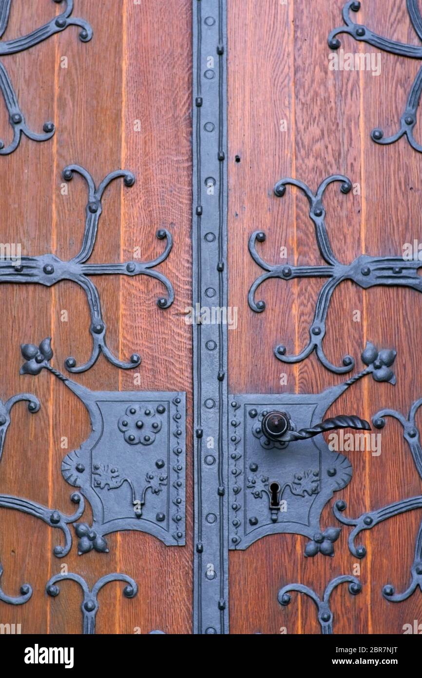 A heavy wooden church door with ornately wrought iron hinges Stock ...