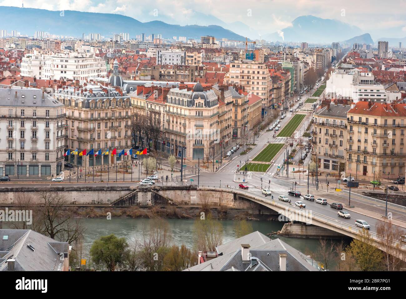 Scenic aerial view of the banks of the Isere river, bridge, roofs and ...