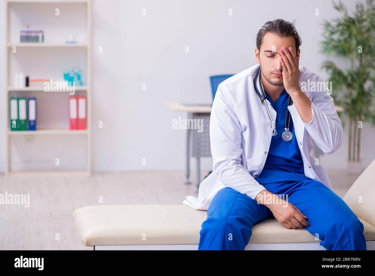 Young doctor being tired after night shift Stock Photo - Alamy