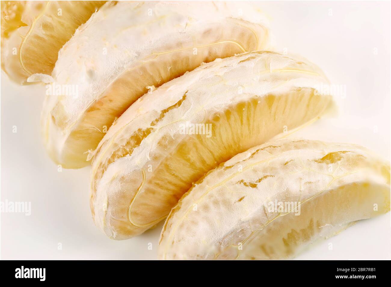 Unpeeled Pomelo segment showing the membranous material around the pulp ...