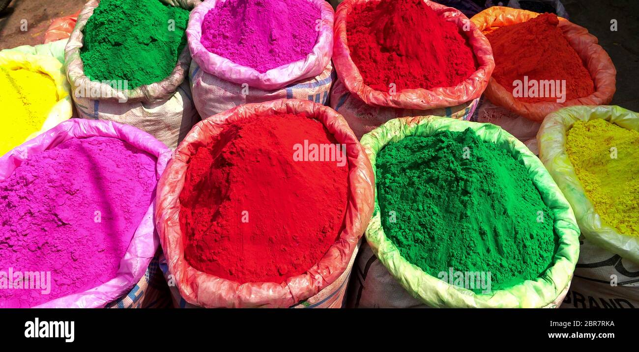 vividly colored bags of holi powder at the spice market in old delhi ...