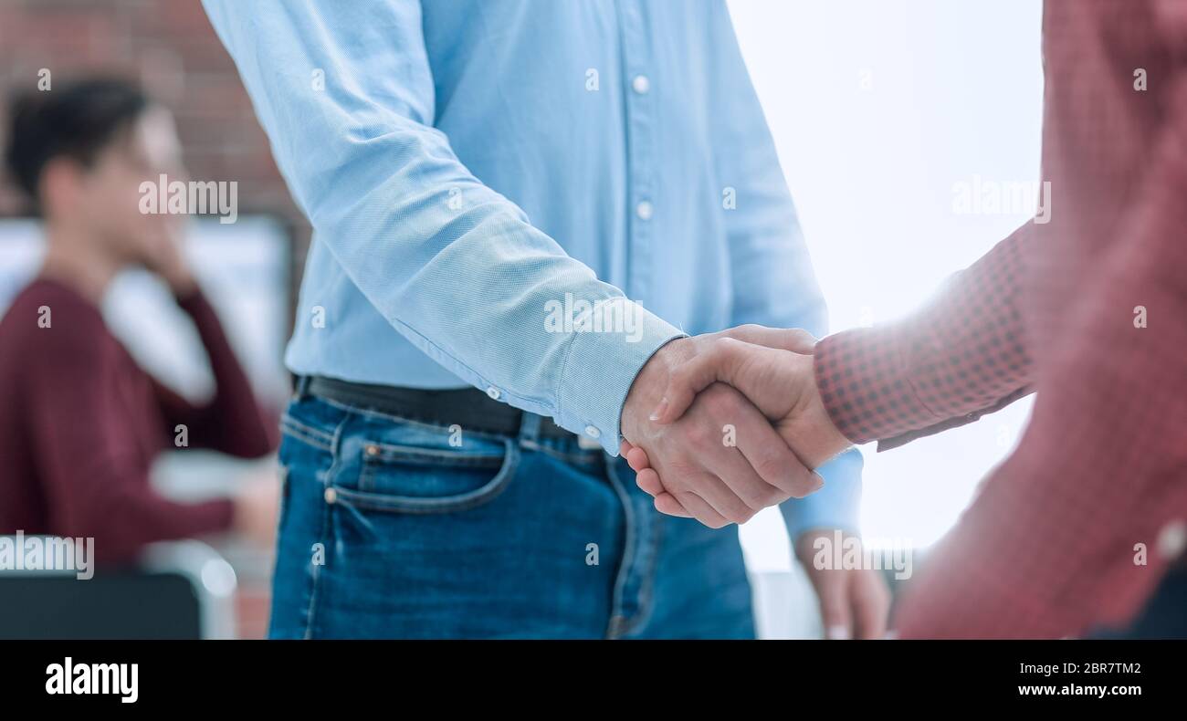 Businessmen making handshake in an office Stock Photo - Alamy