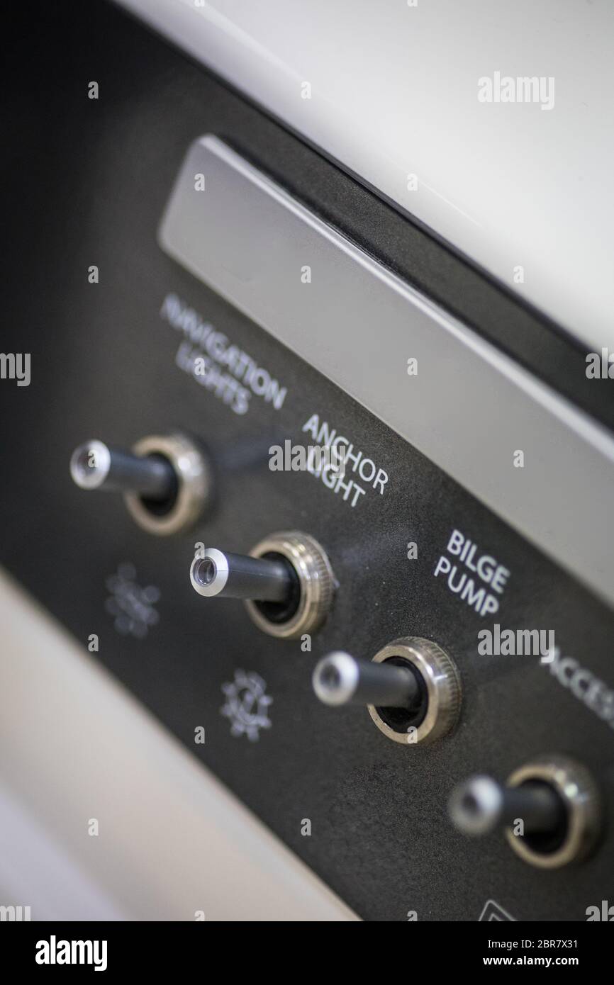 Close up shot with a control panel with switches in a luxury speed boat ...