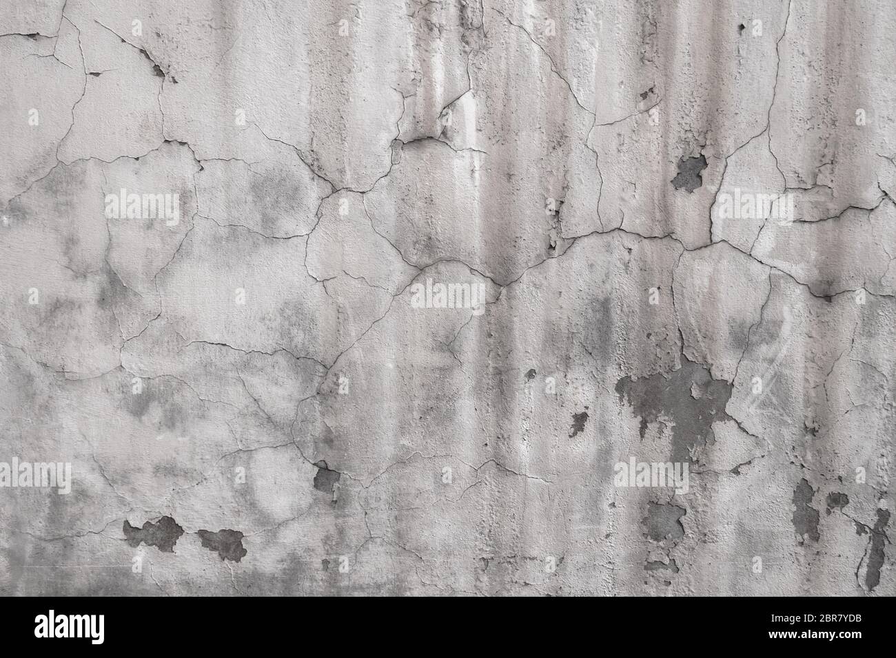 Plaster falling off of an old wall. Old cracked and ruined wall with ...