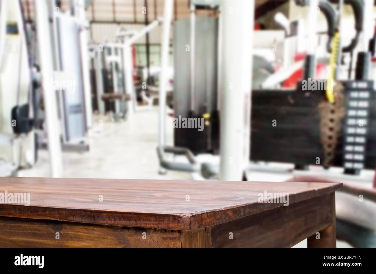 Wooden table on blurred background of fitness gym interior of modern ...