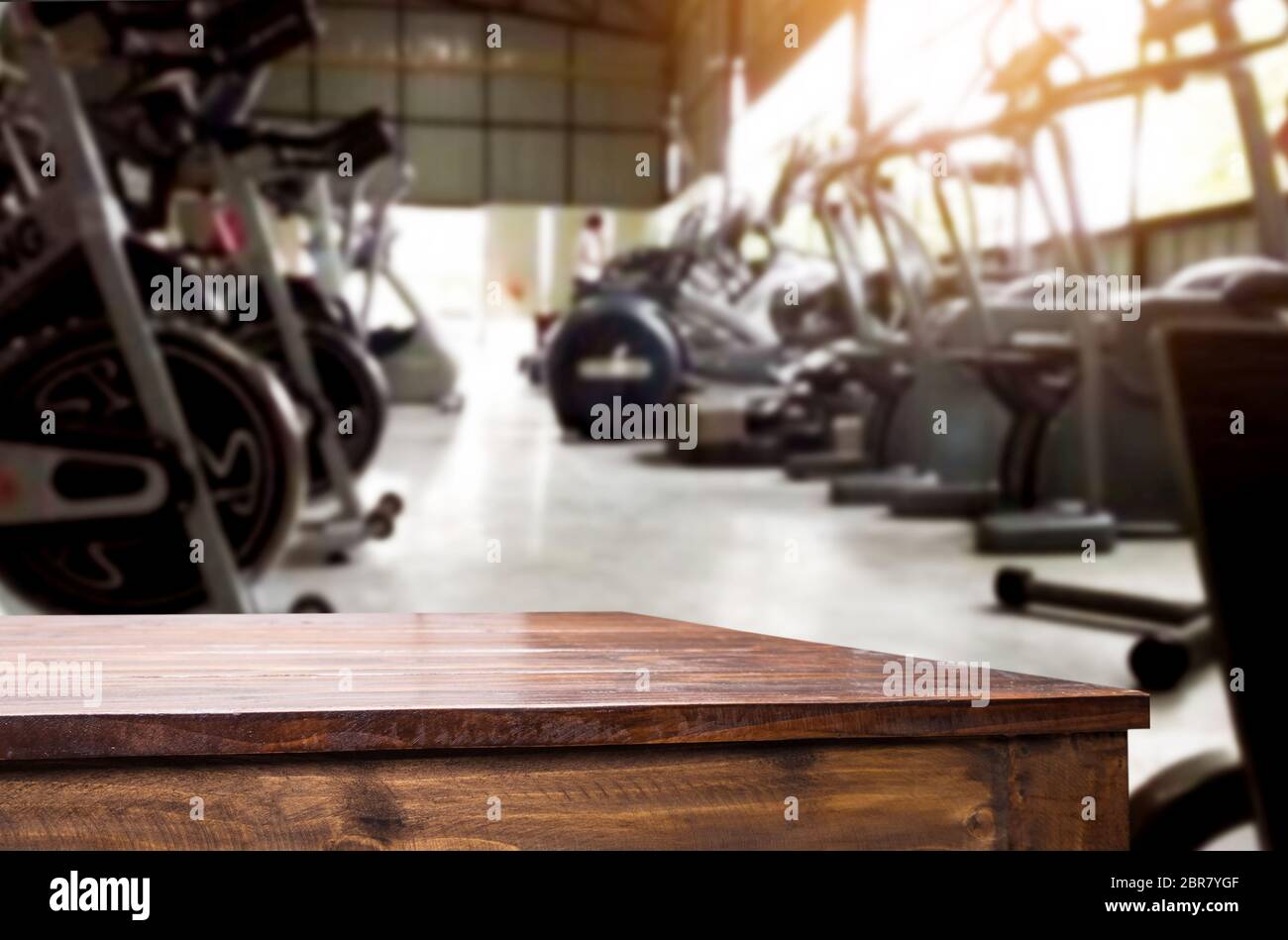 Wooden table on blurred background of fitness gym interior of modern ...