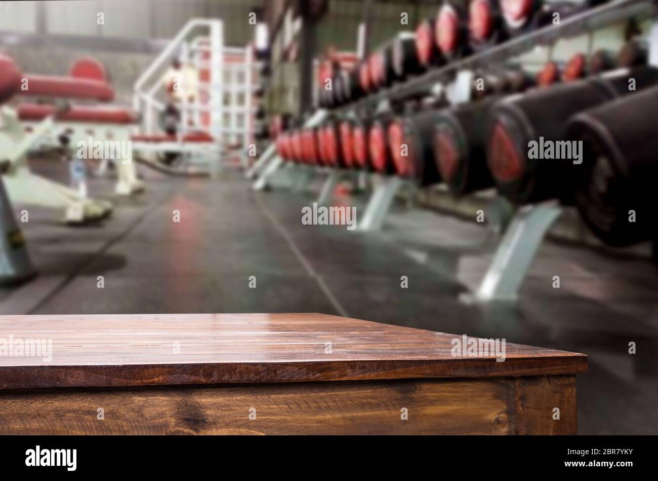 Wooden table on blurred background of fitness gym interior of modern ...