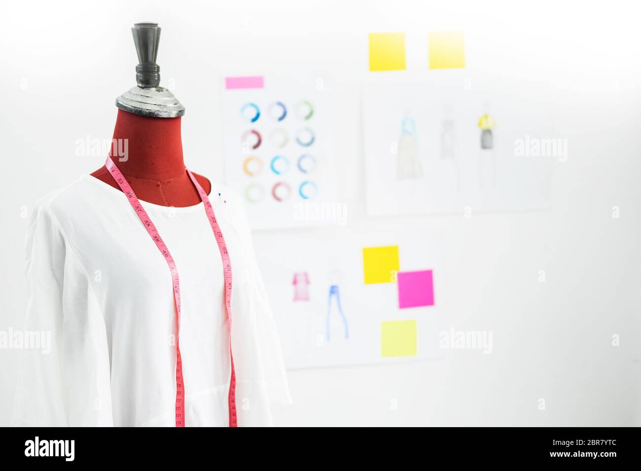 Asian tailor adjusts garment design on mannequin in workshop make a ...