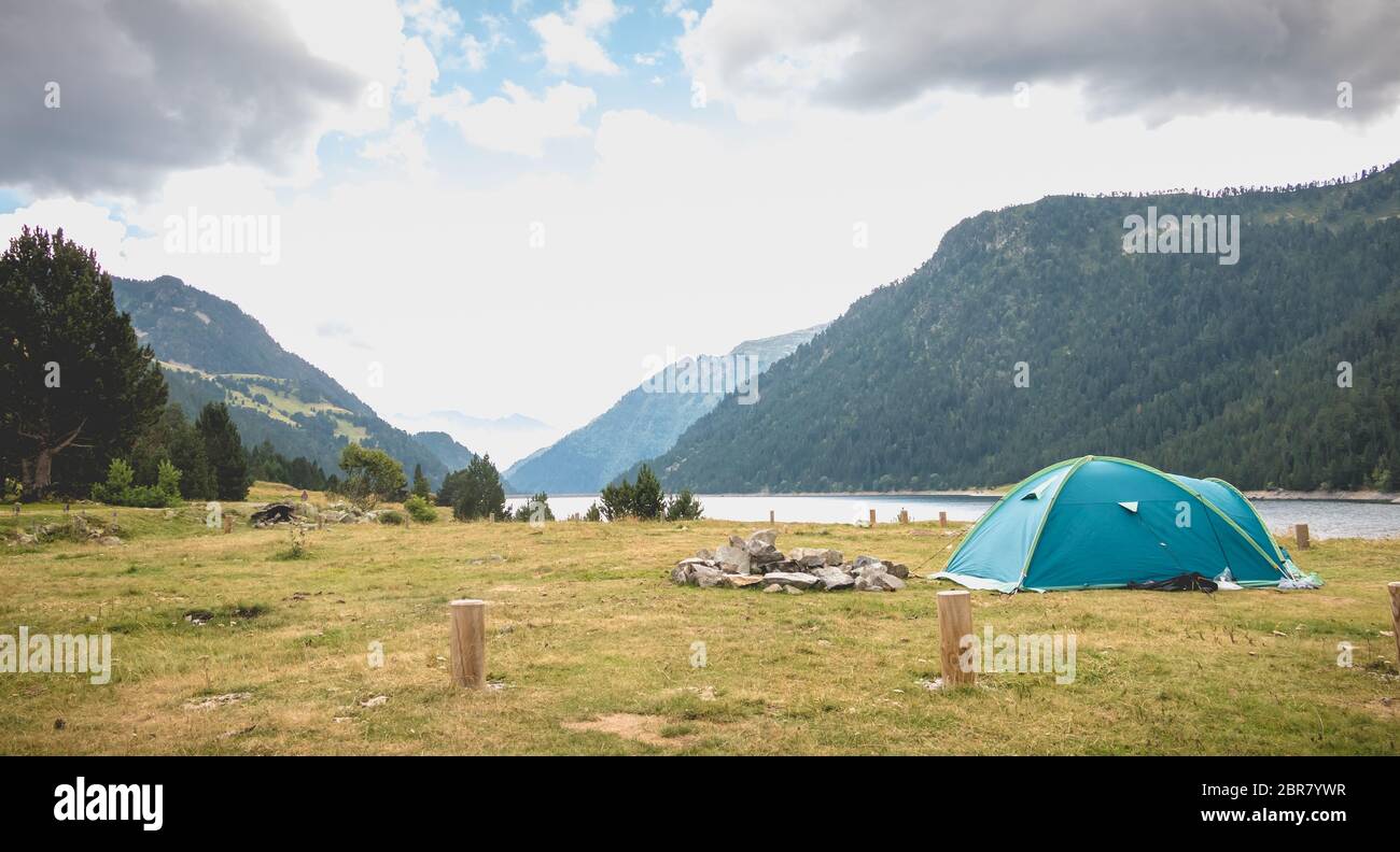 Wild camping atmosphere on a lake in the middle of the Pyrenees in ...
