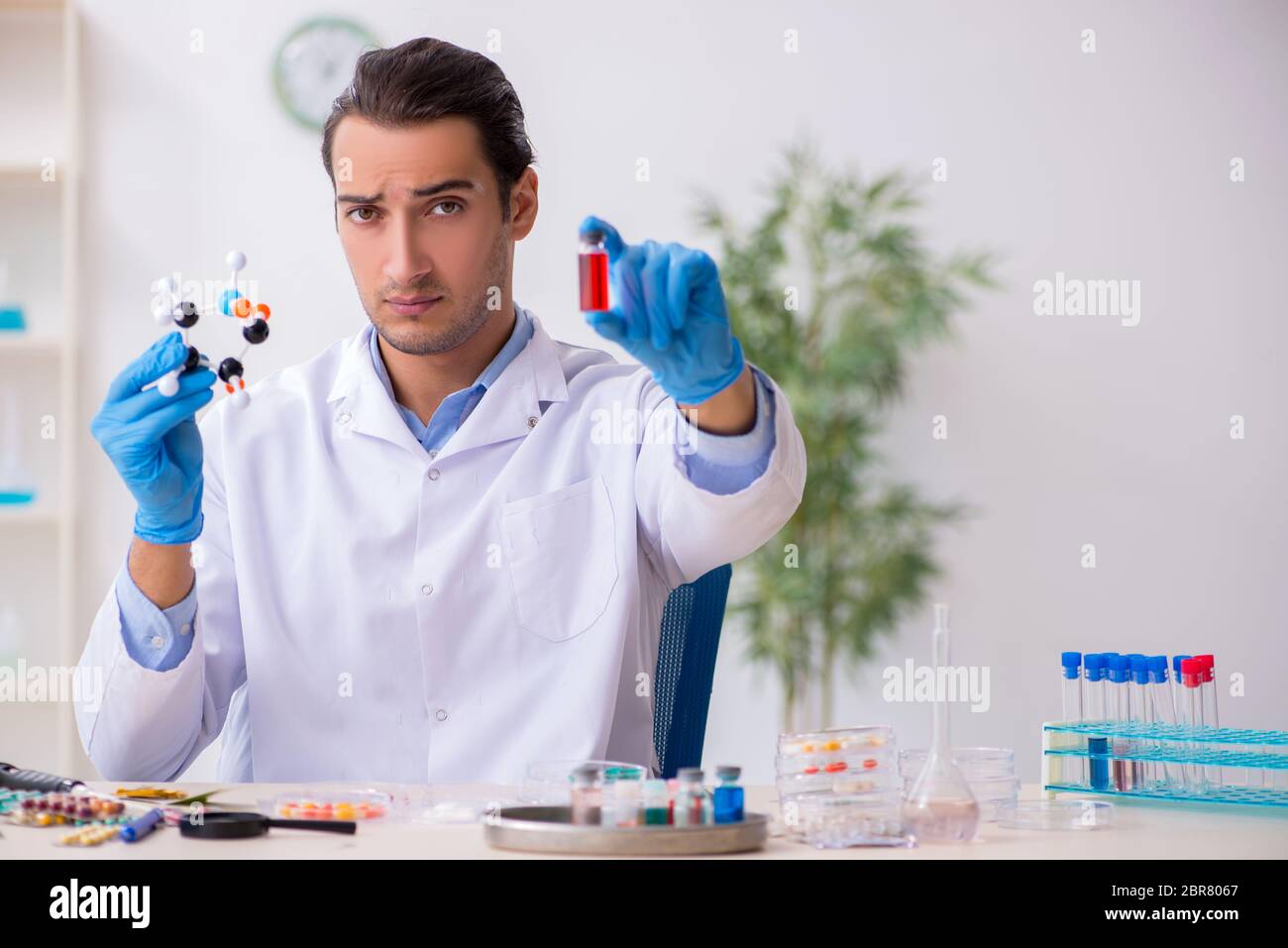 Young male lab assistant in the drug synthesis concept Stock Photo - Alamy