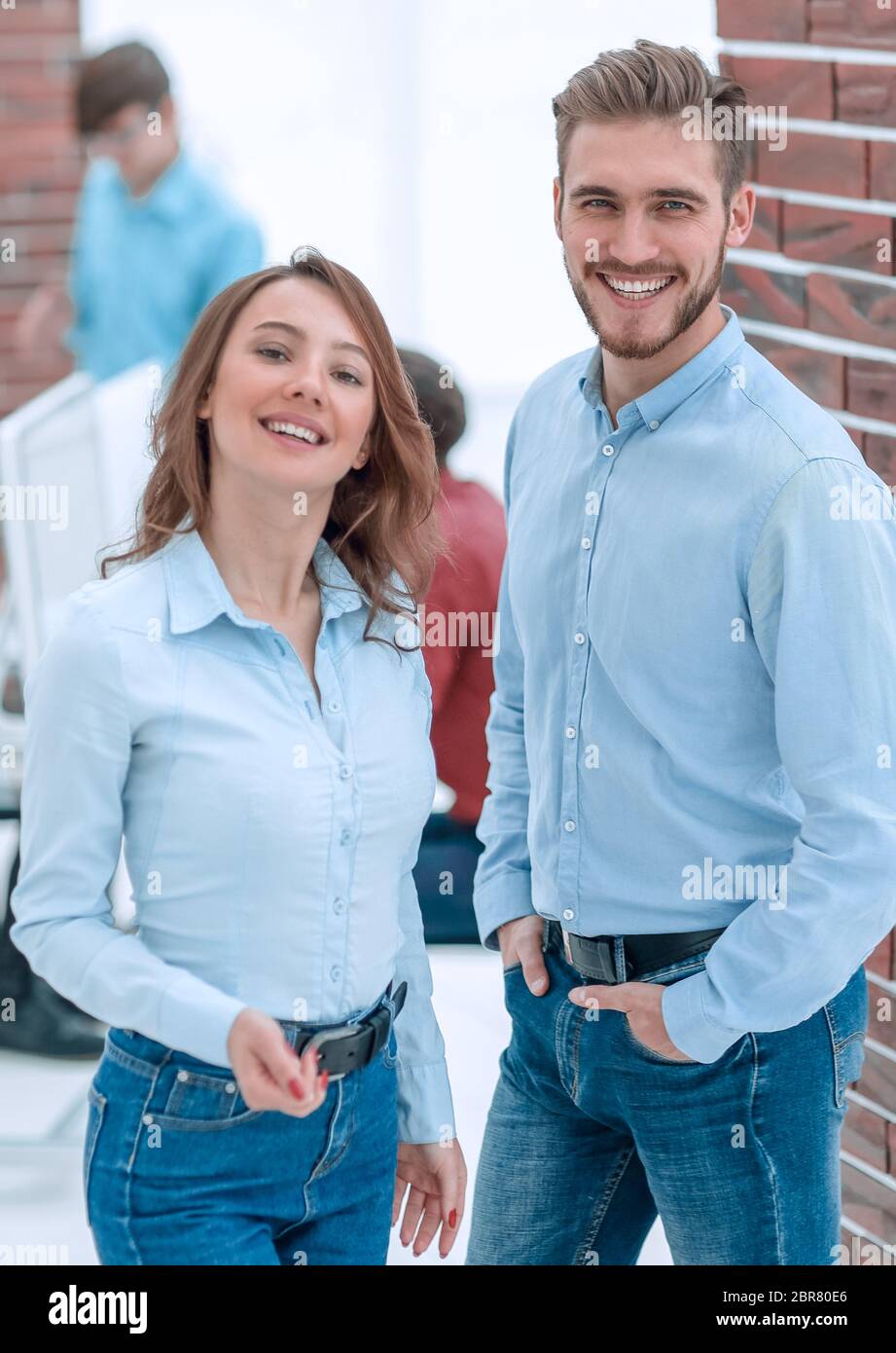 Portrait of smiling designers standing in office Stock Photo - Alamy