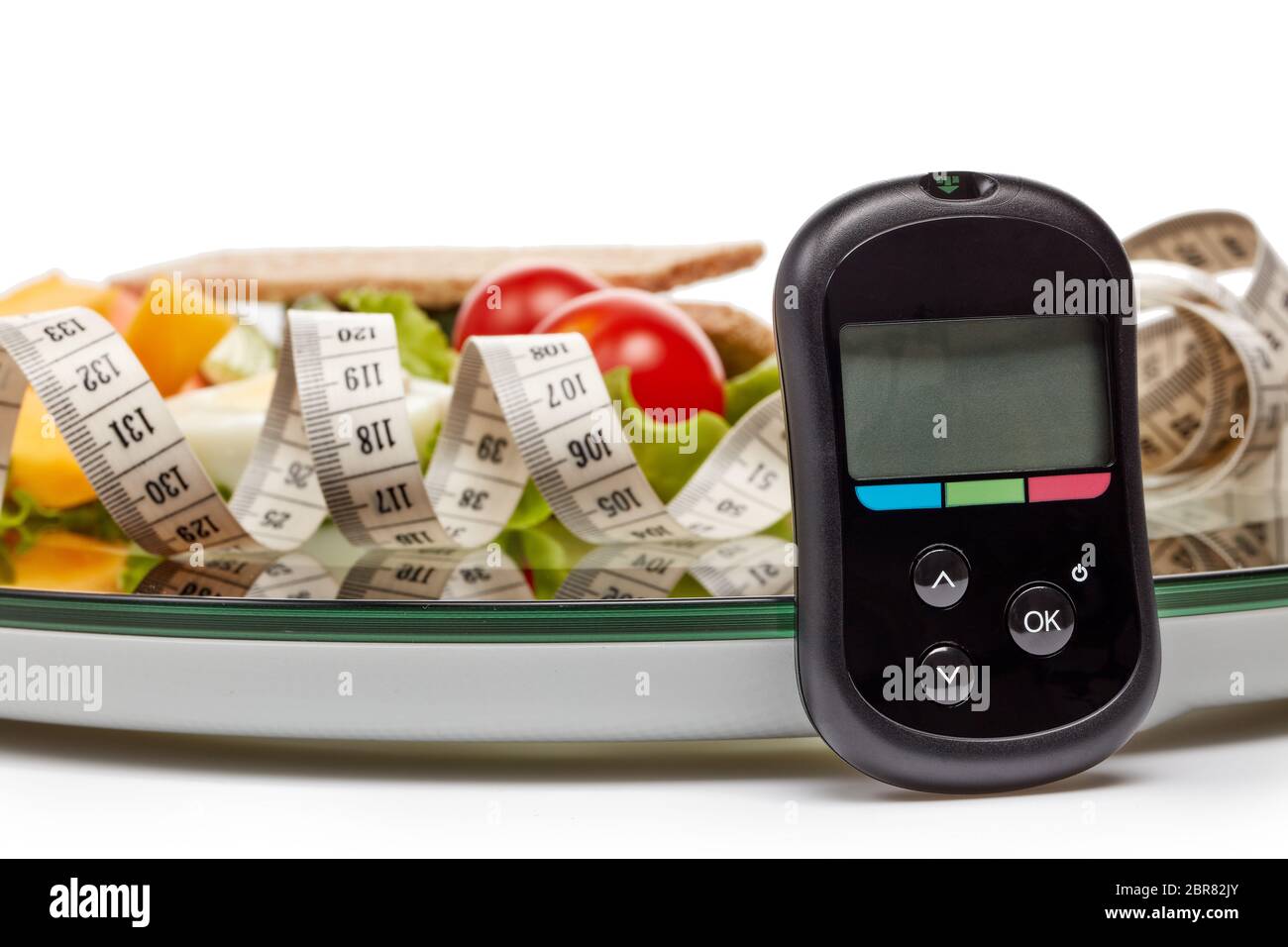 Still life with healthy food, scales, measuring tape and blood glucose ...