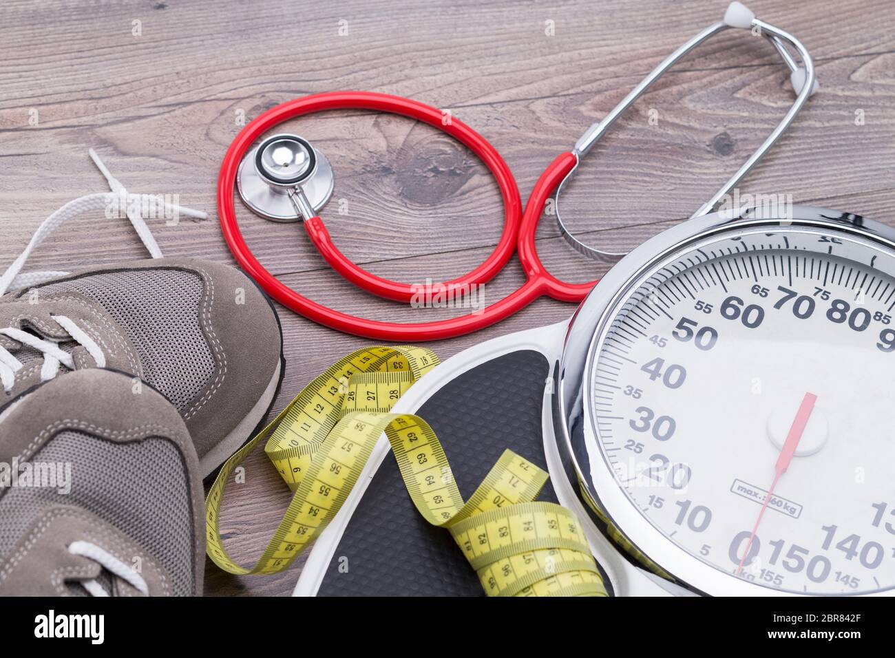 Healthy concept with sport shoes, stethoscope and weighing scales Stock ...