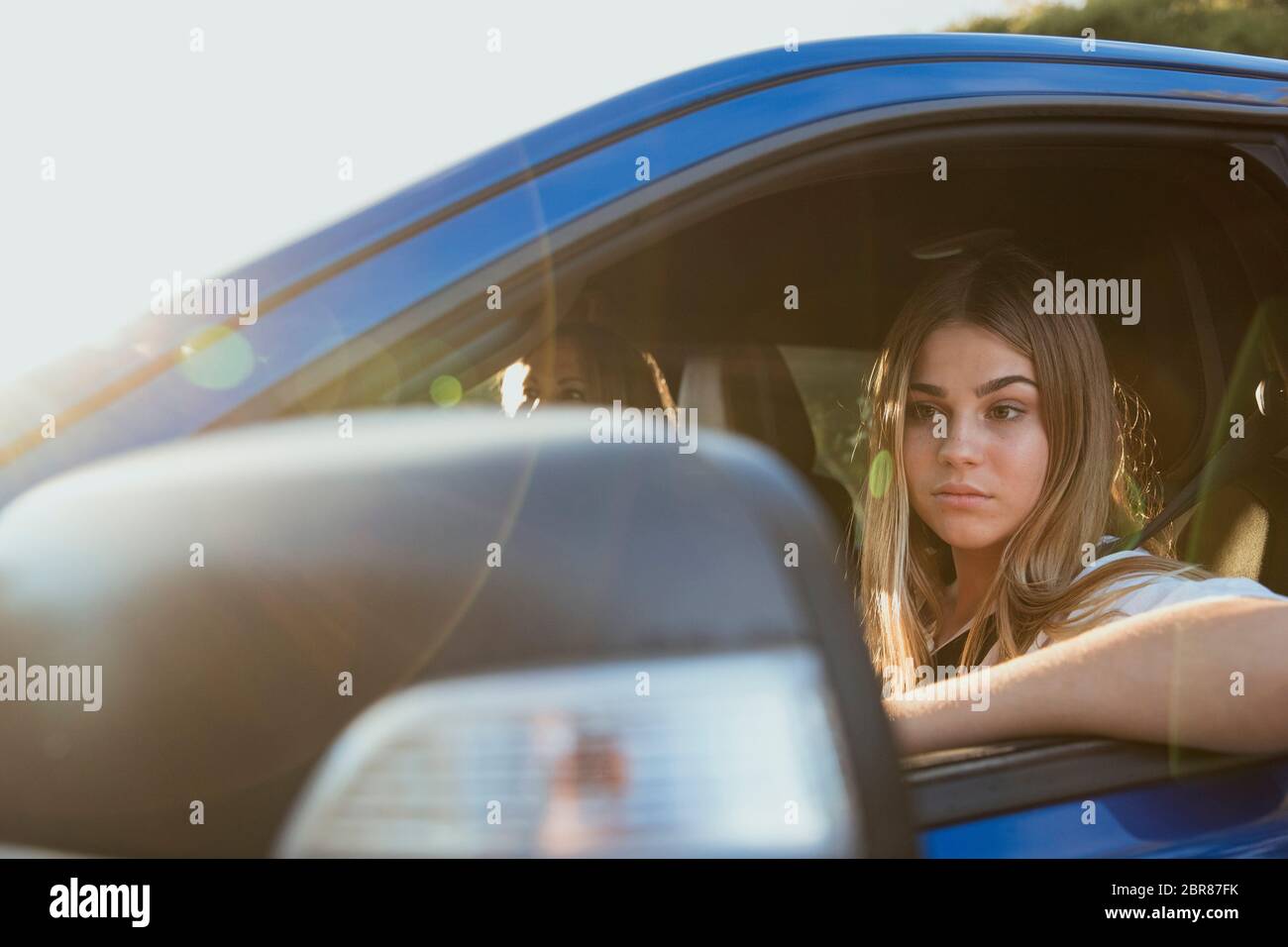 Young girl going for a drive with her mother Stock Photo - Alamy