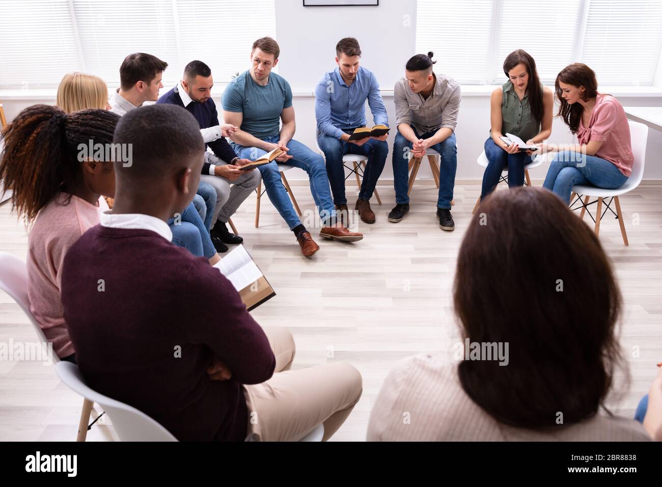 Group Of Young Multi-ethnic People Reading Holy Bible Together Stock ...