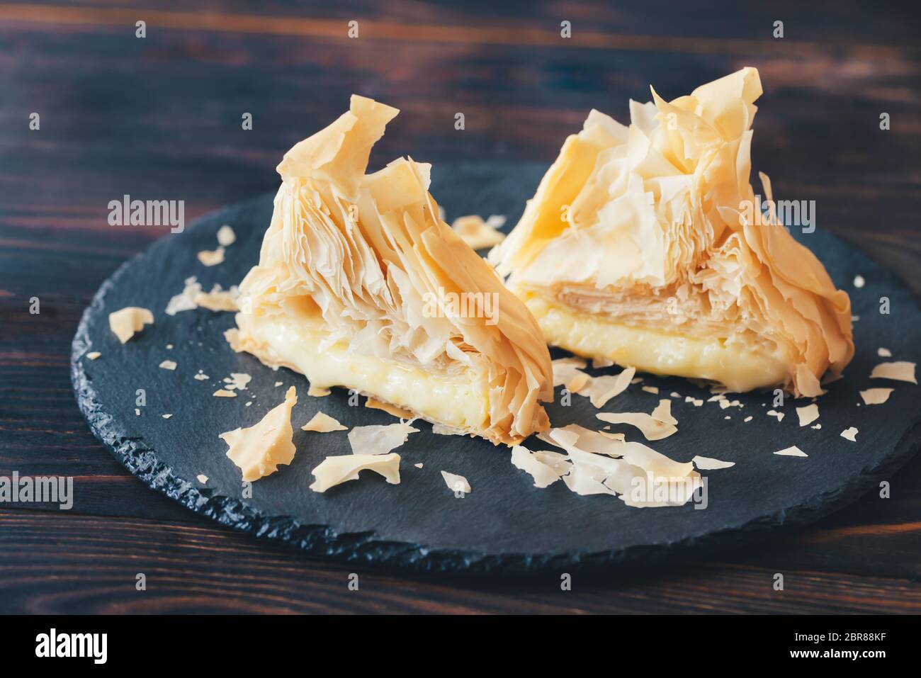 Baked Camembert in phyllo pastry on the black stone board Stock Photo ...
