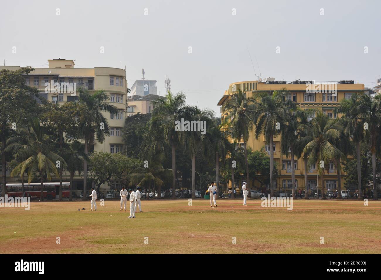 A game of cricket at the Oval Maidan in Mumbai, with Art Deco ...
