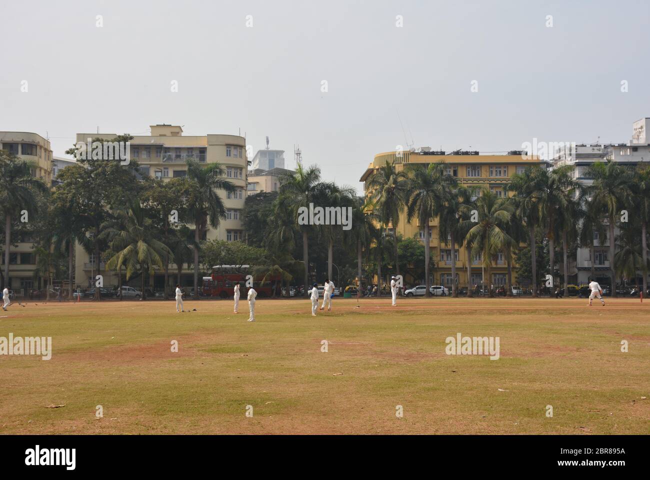 A game of cricket at the Oval Maidan in Mumbai, with Art Deco ...