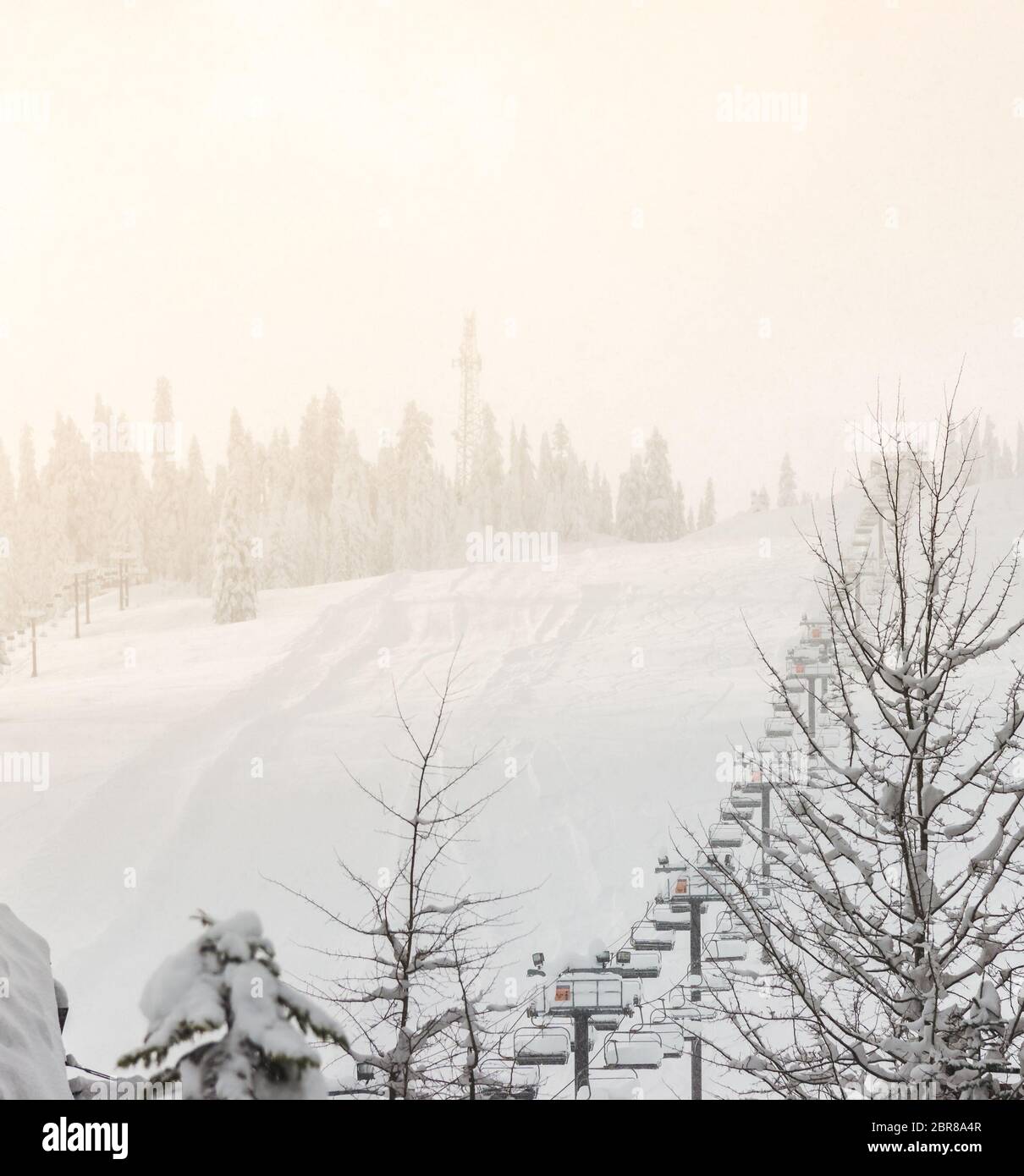scene of ski lift with seats over the mountain and paths from skies and ...