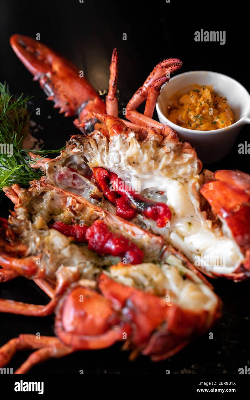 Grilled boston lobster serve with butter chilli sauce with lemon and ...