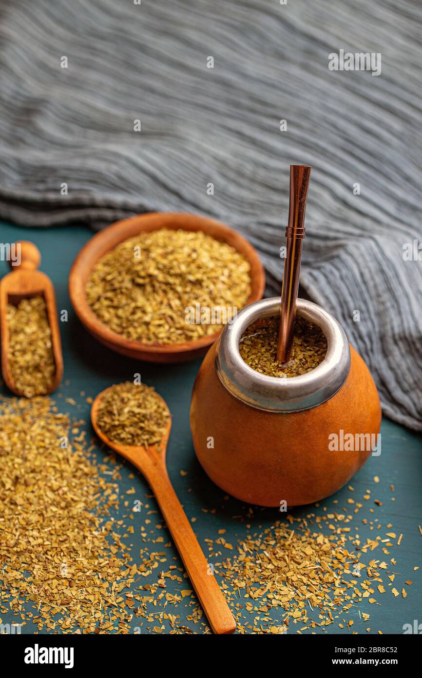 Pile of mate tea leaves and mate tea drink served in calabash gourd ...