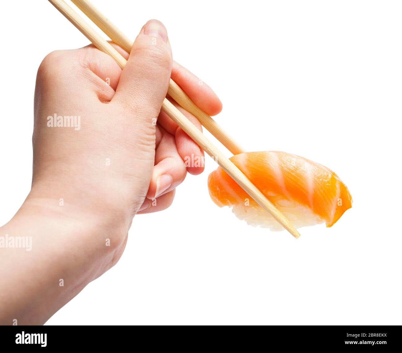 female hand with wooden chopsticks holds sake nigiri sushi with salmon fish isolated on white ...