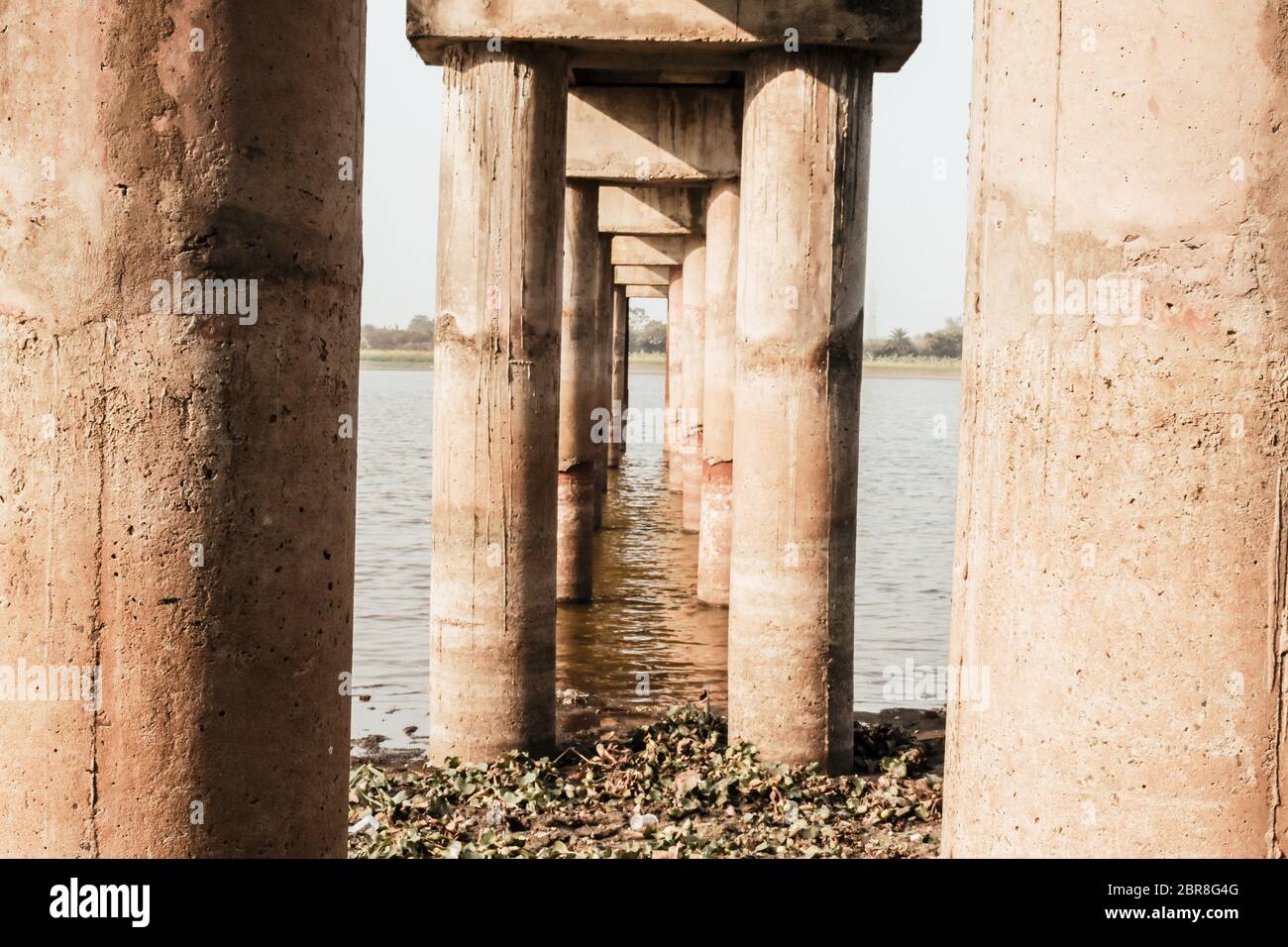 A river bridge under construction, pillars of urban architecture of ...