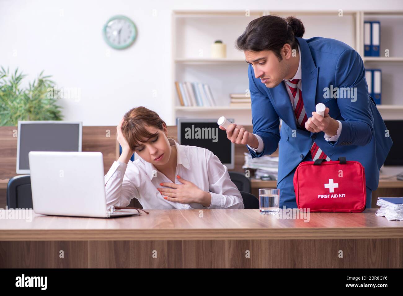 Employee receiving first aid in office Stock Photo - Alamy
