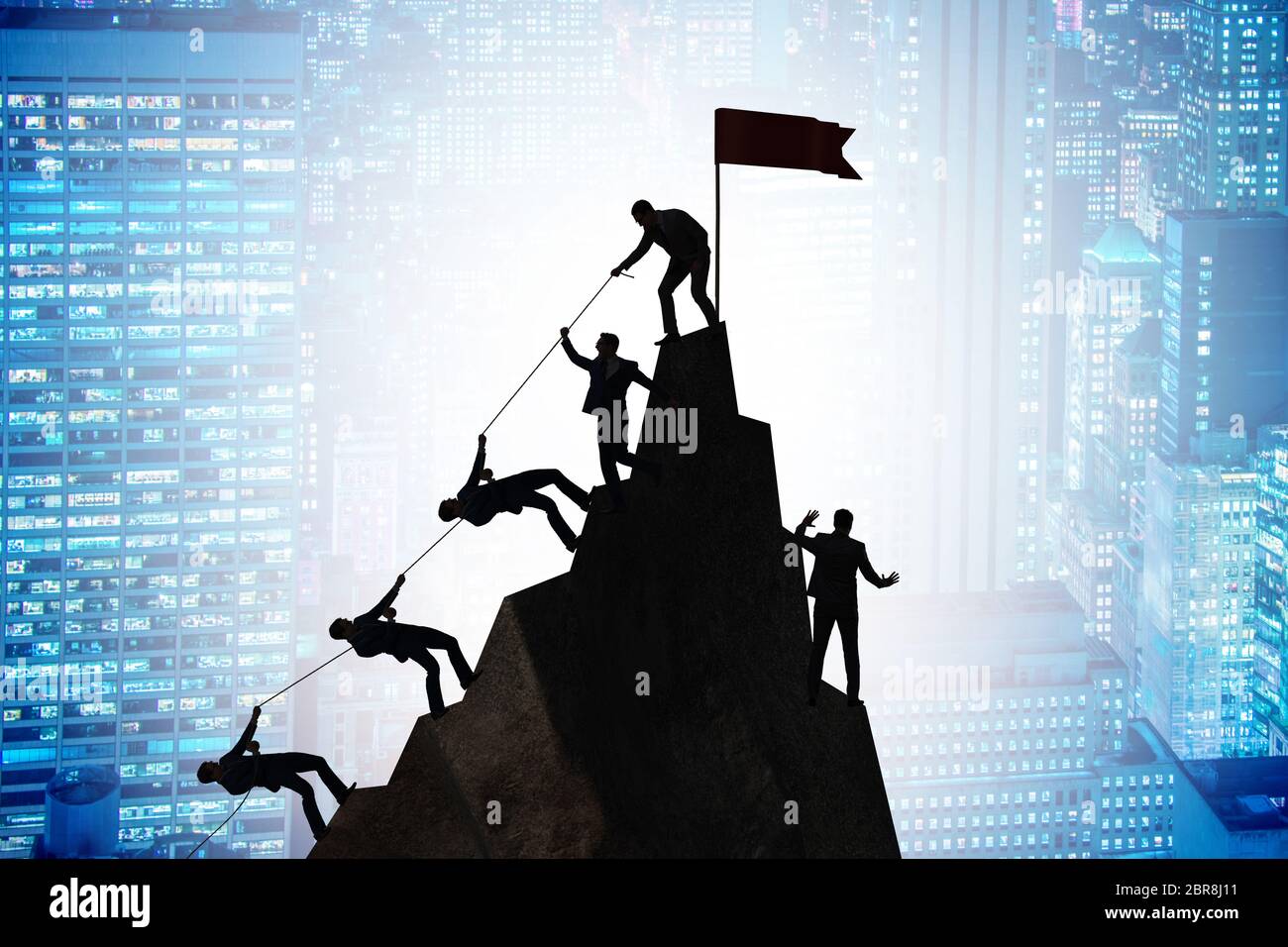 Concept of teamwork with team climbing mountain Stock Photo - Alamy