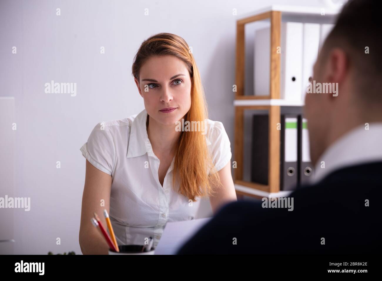 Blonde Young Female Recruiter Looking At Candidate In Office Stock ...