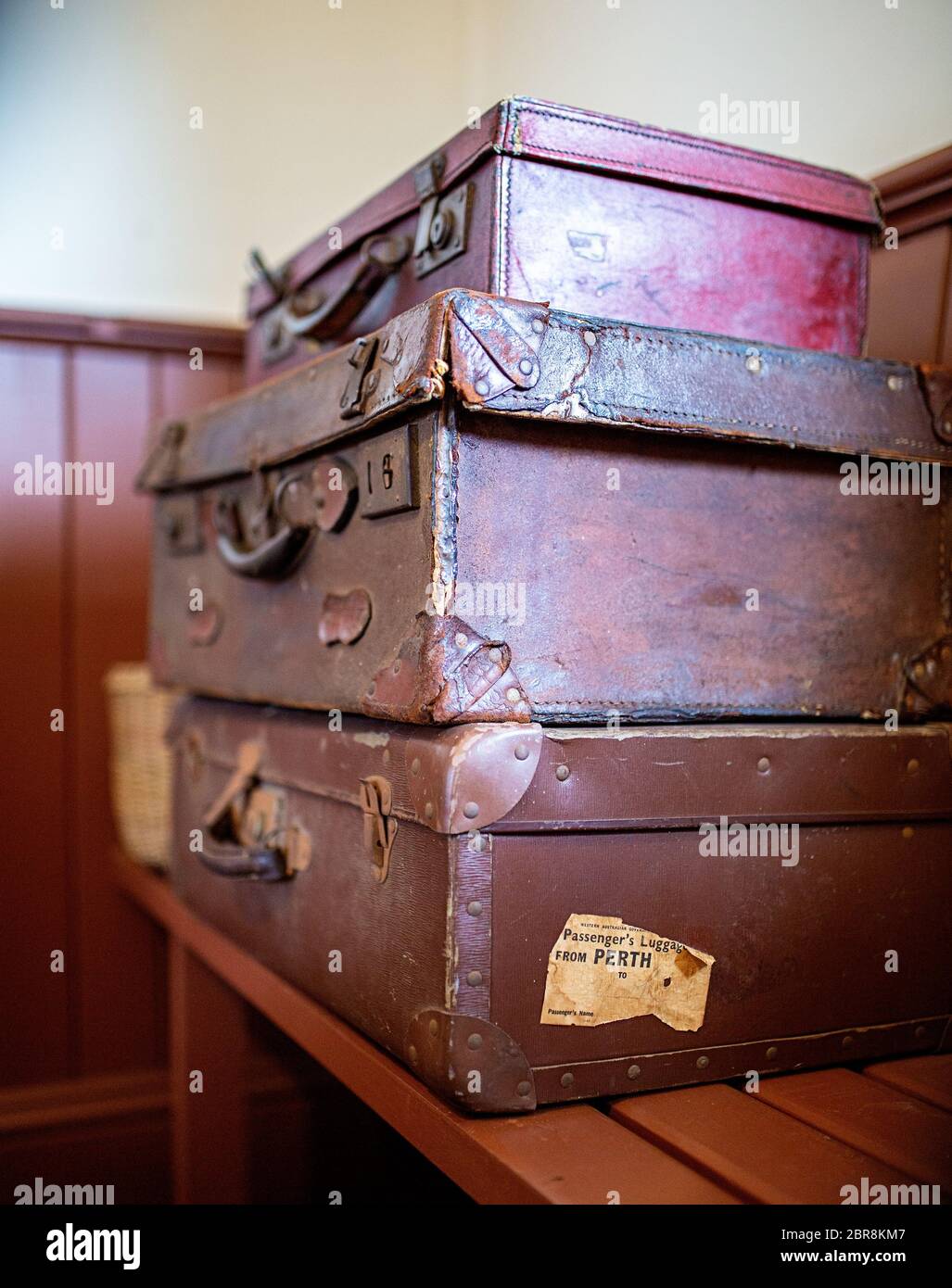 Old vintage suitcases stacked with an old label showing Stock Photo - Alamy