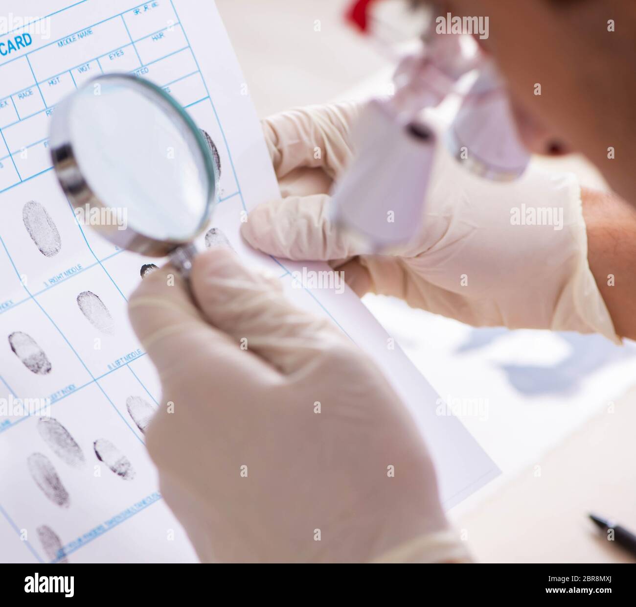 The forensic expert studying fingerprints in the lab Stock Photo - Alamy
