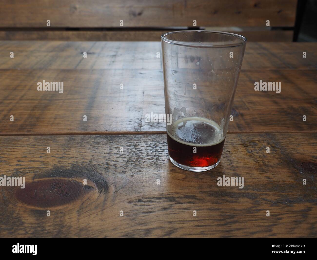 a pint of British ale beer on a wooden pub table Stock Photo - Alamy