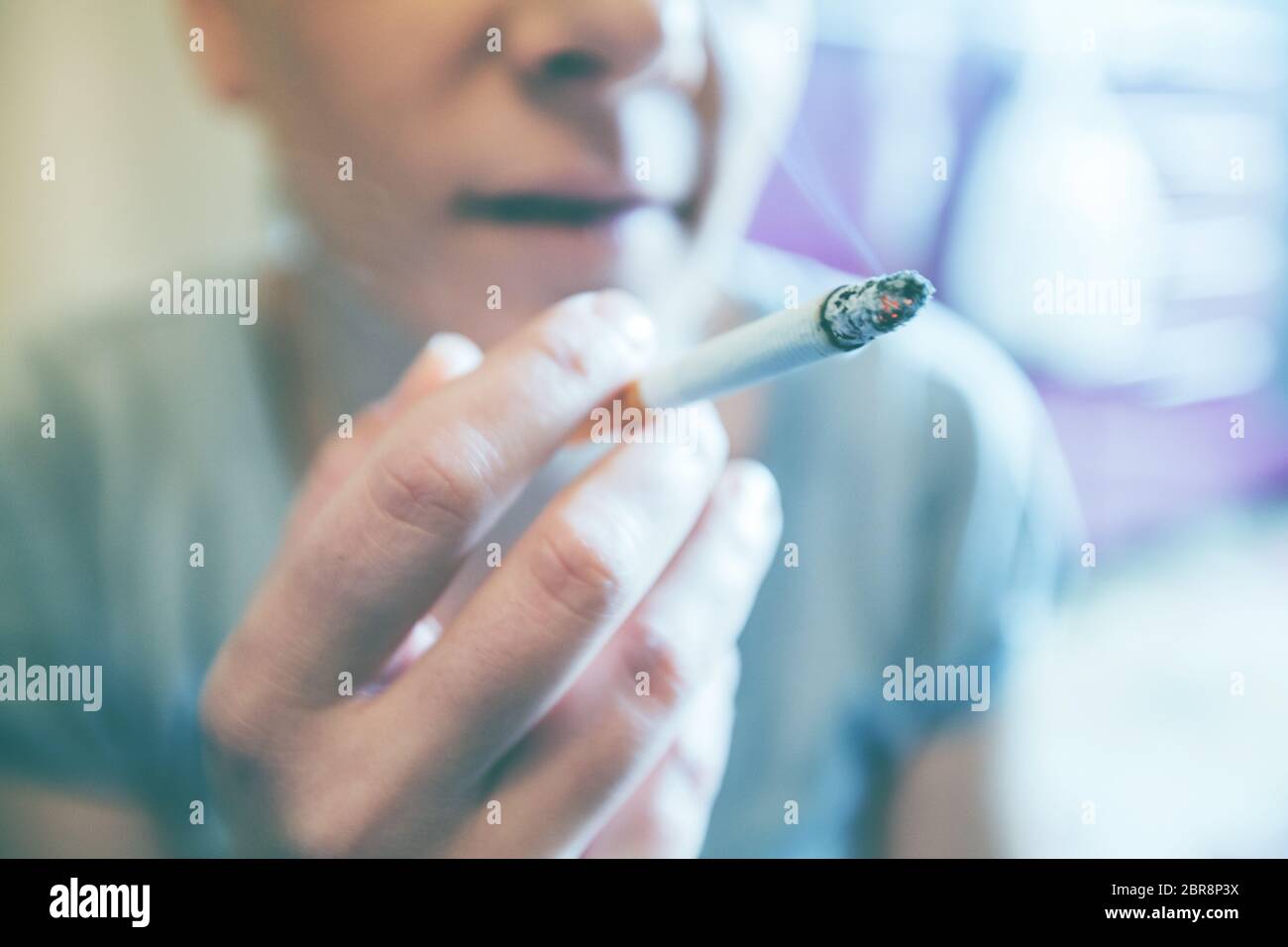 Closeup of depressed woman smoking cigarette Stock Photo - Alamy