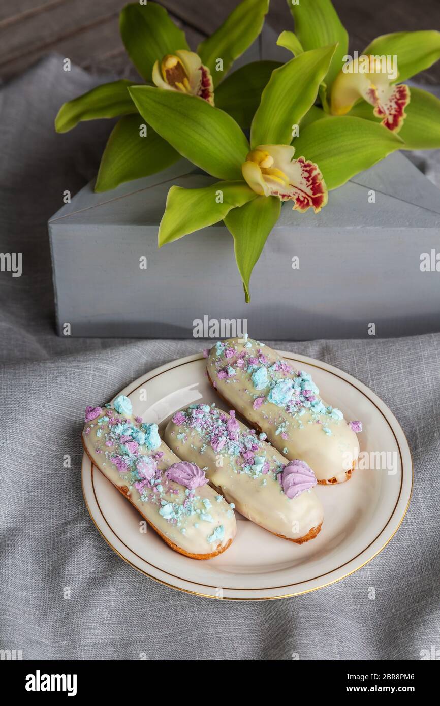 Traditional french eclairs is typically piped into an oblong shape with ...