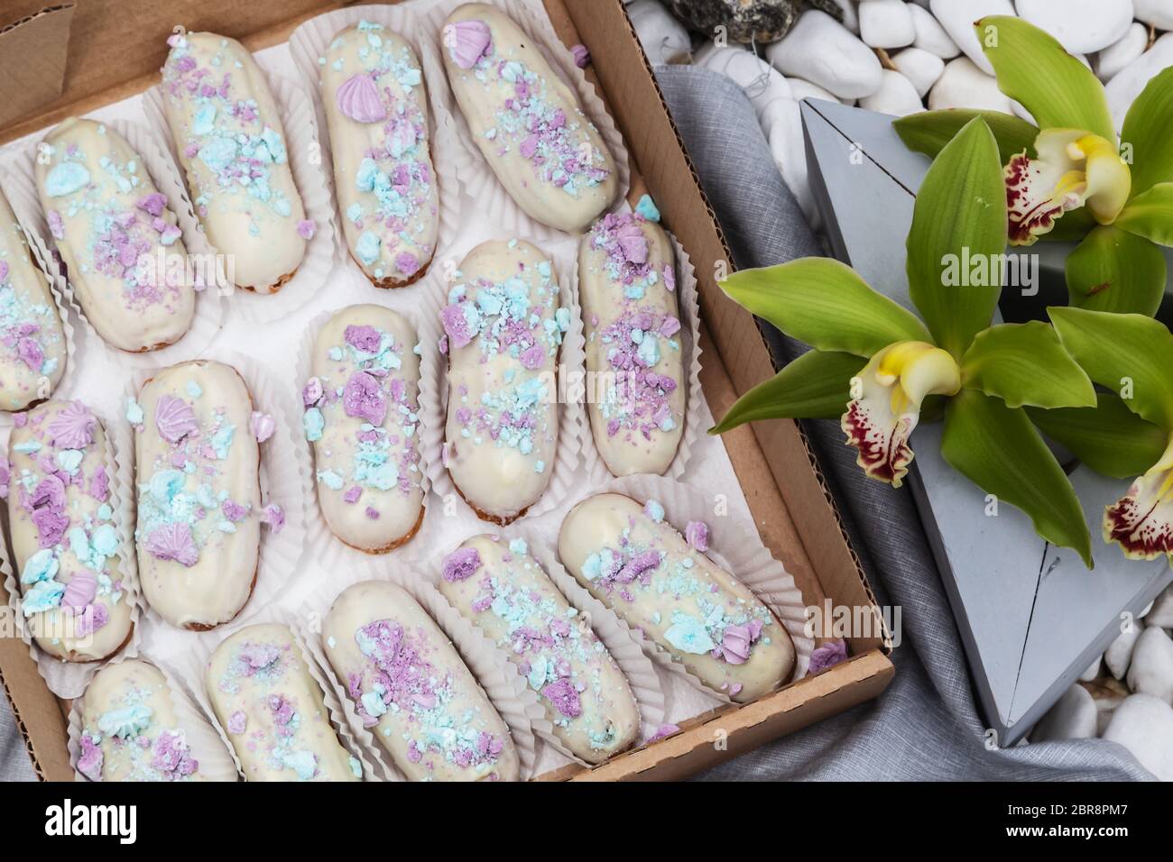 Traditional french eclairs is typically piped into an oblong shape with ...