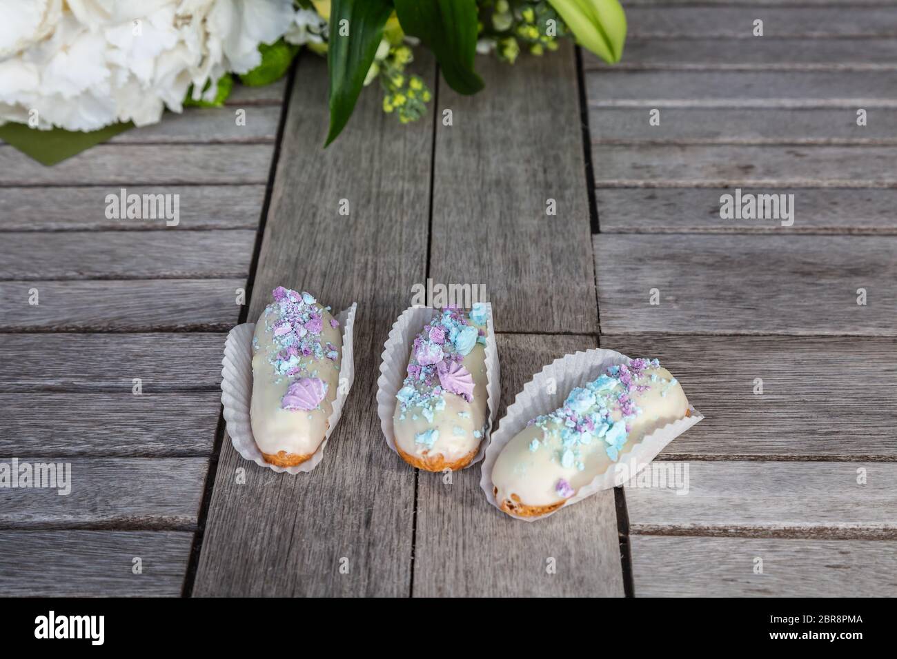 Traditional french eclairs is typically piped into an oblong shape with ...