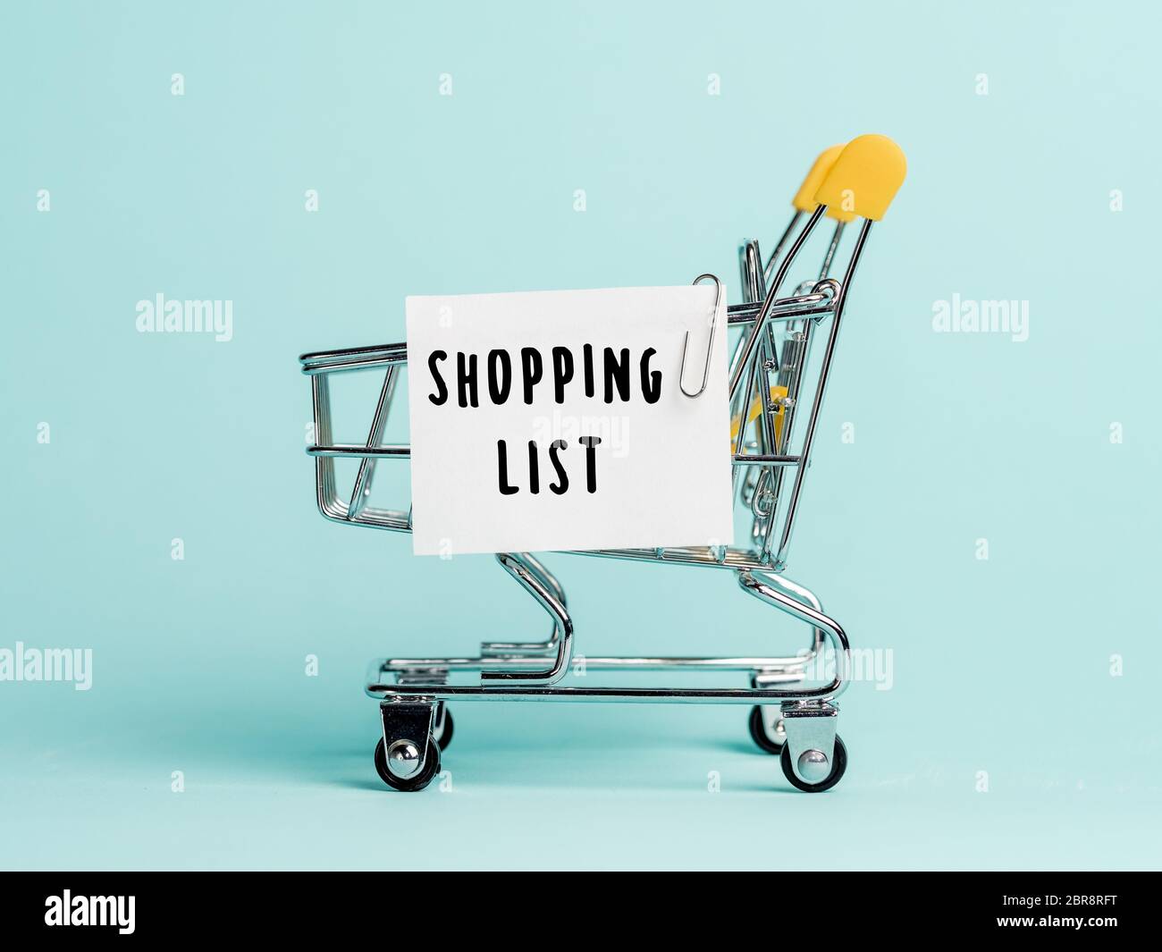 Shopping cart and text shopping list on white paper note list. Shopping ...
