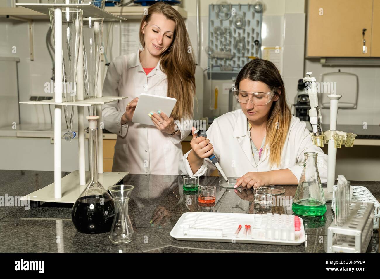 Team of two, Caucasian white, female laboratory technicians in white ...