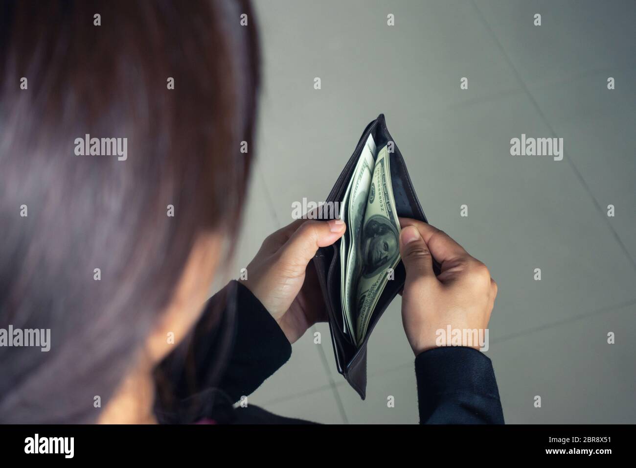 woman taking out money dollar banknotes from wallet Stock Photo - Alamy