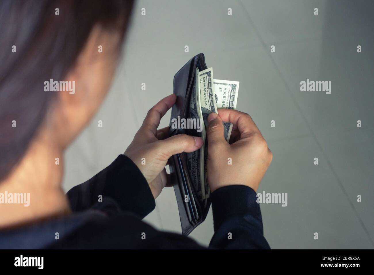 woman taking out money dollar banknotes from wallet Stock Photo - Alamy
