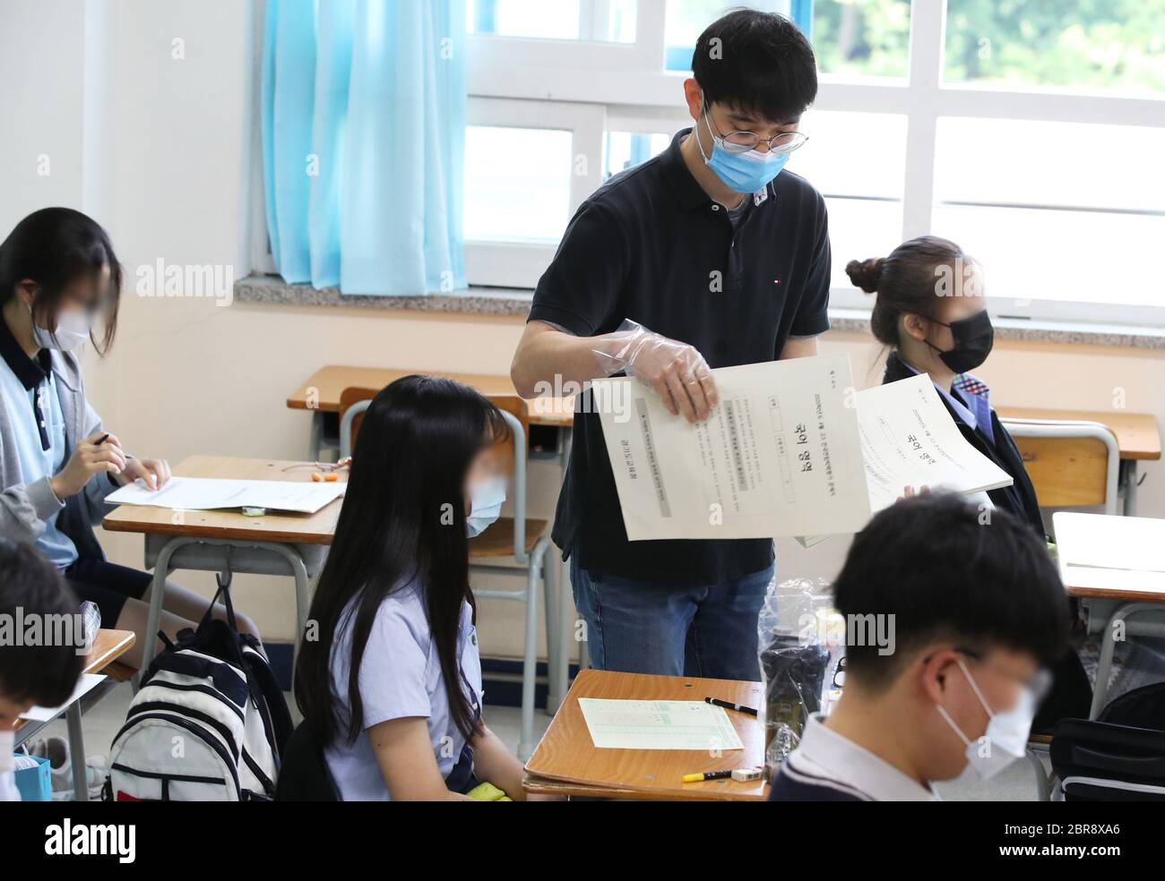 21st May, 2020. Second day of school reopening A teacher wearing ...